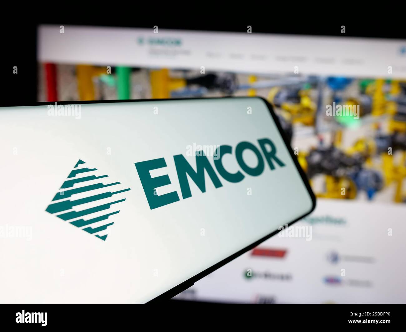 In this photo illustration, a cellphone with the logo of American engineering company EMCOR ...
