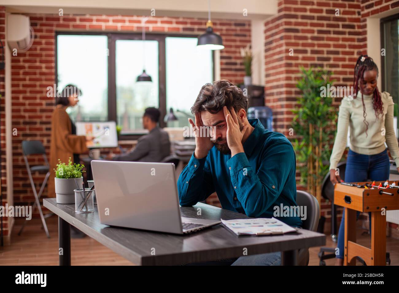 Frustrated businessman leaning on desk, struggling with marketing ...