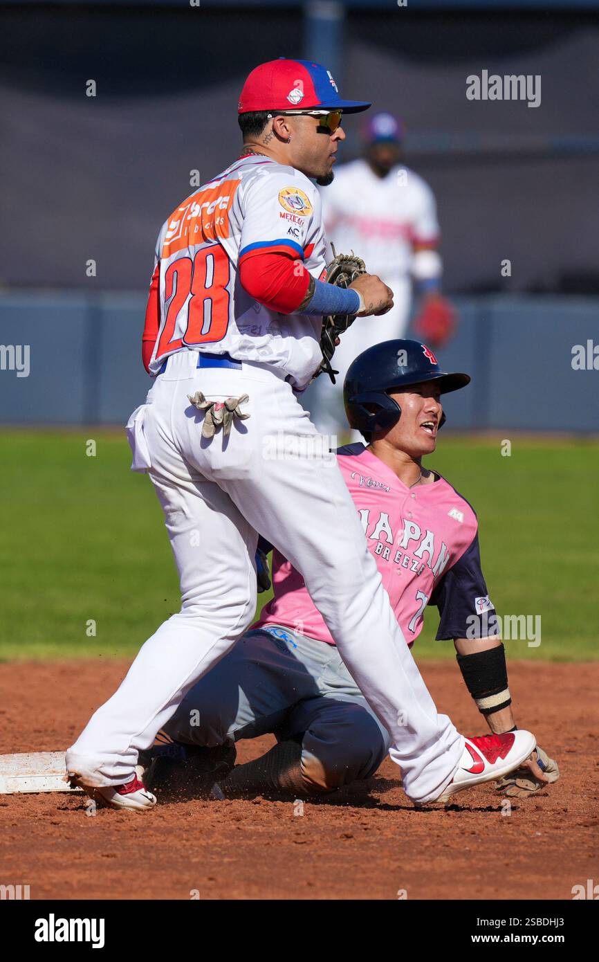 Japan's Yuta Hamada, bottom, slides safely into second base alongside ...