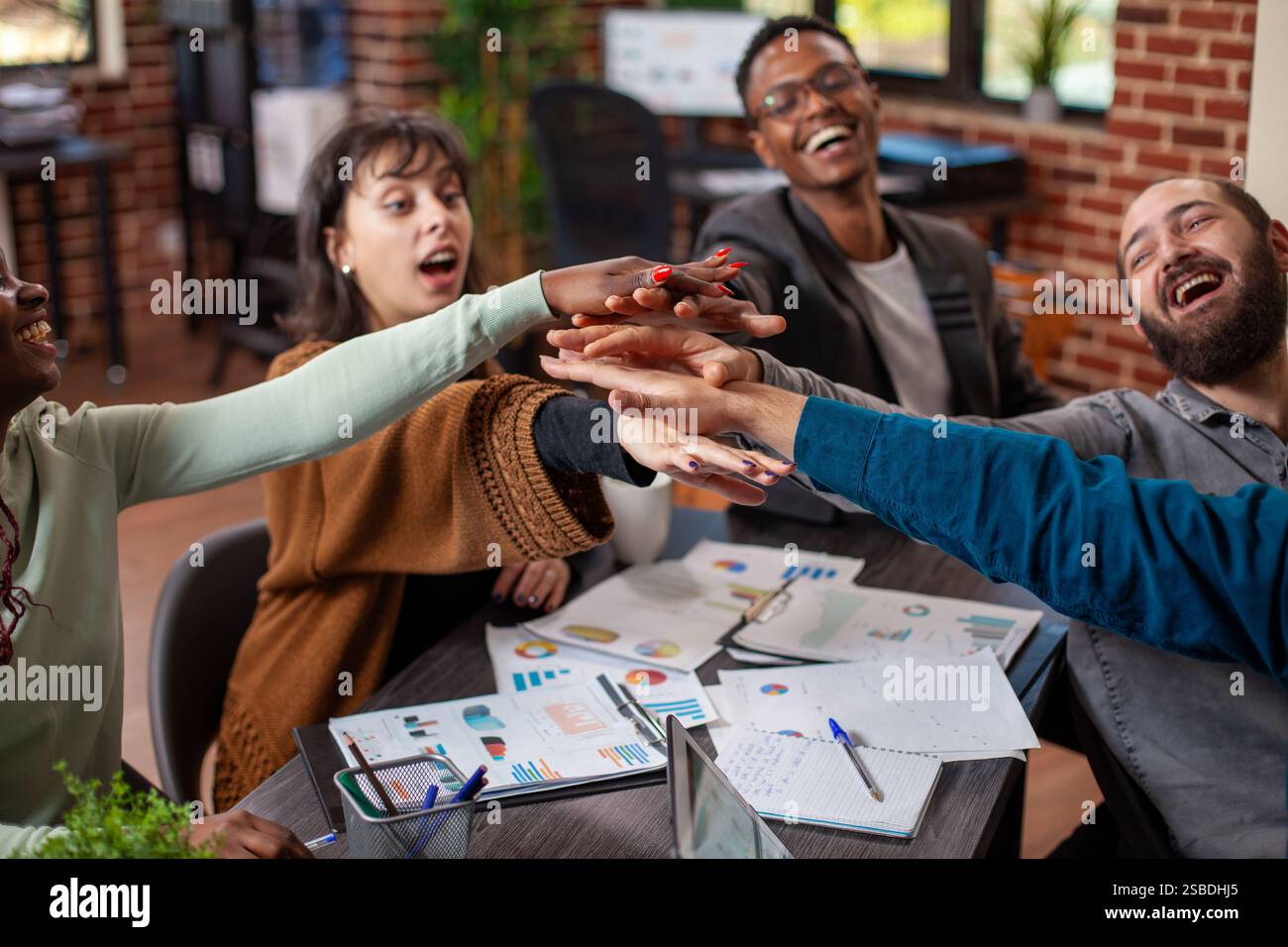 Male and female colleagues bonding through cheerful gesture, fostering ...