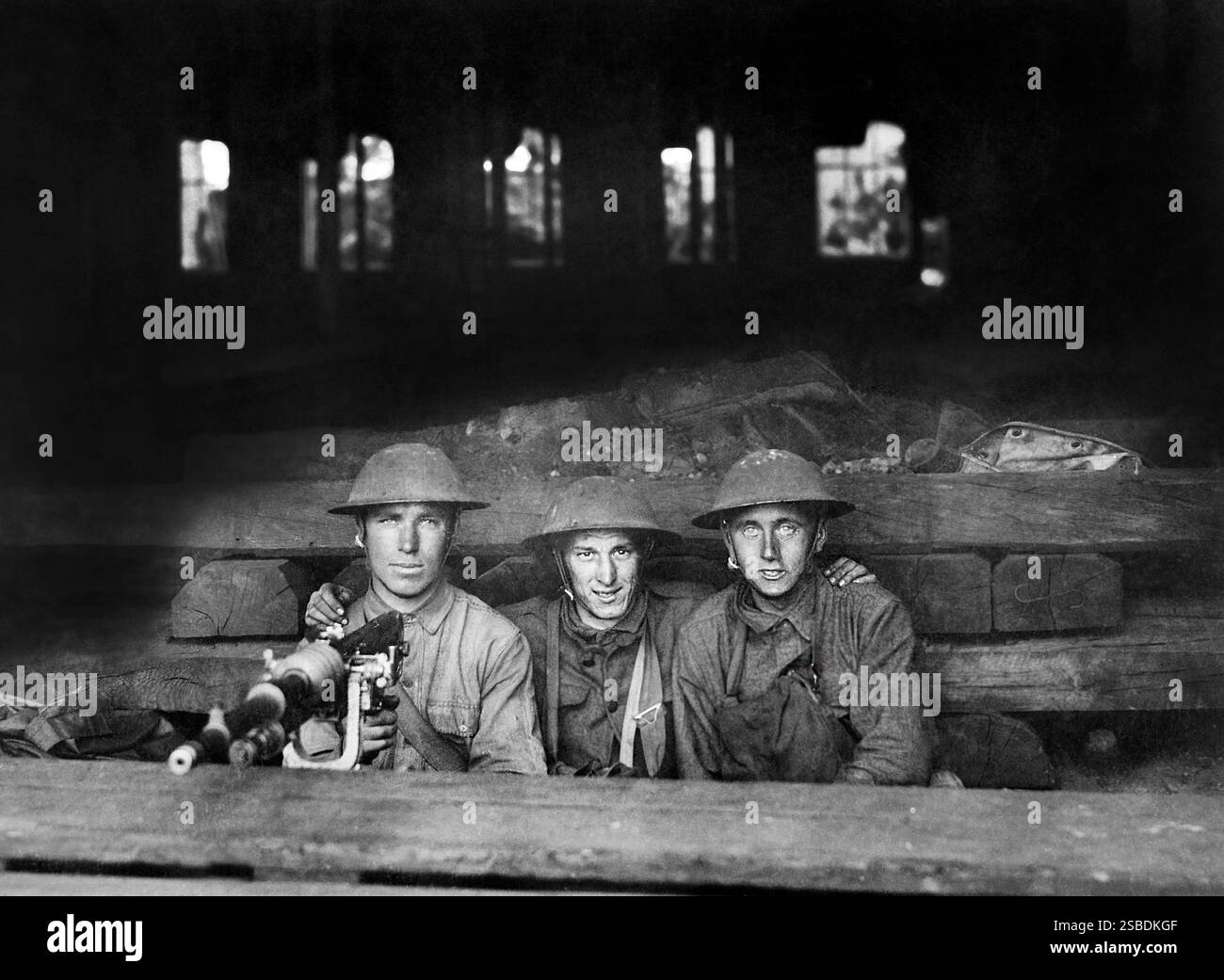 Three U.S. soldiers with machine gun set up in railroad shop, Company A ...