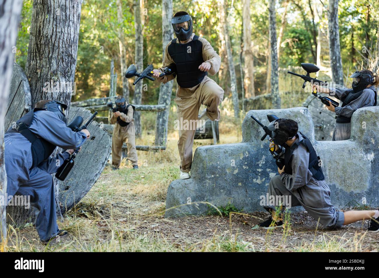 Team of paintball players attacks enemy at an army training ground ...