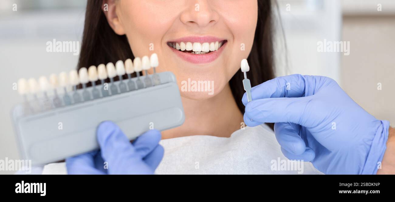 Dentist applying sample from tooth scale to happy patient teeth Stock ...