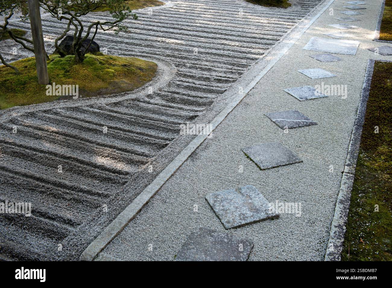 Japanese aesthetic in geometric pattern of raked white sand beside a ...