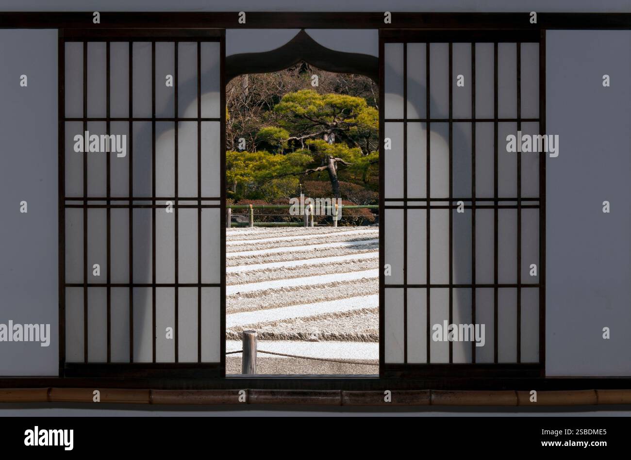 Sliding shoji paper screen window covering offering a peek view at the ...