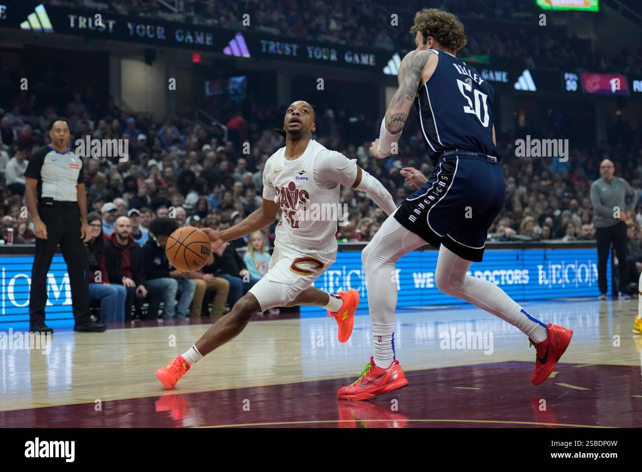 Cleveland Cavaliers guard Darius Garland, center left, drives around ...
