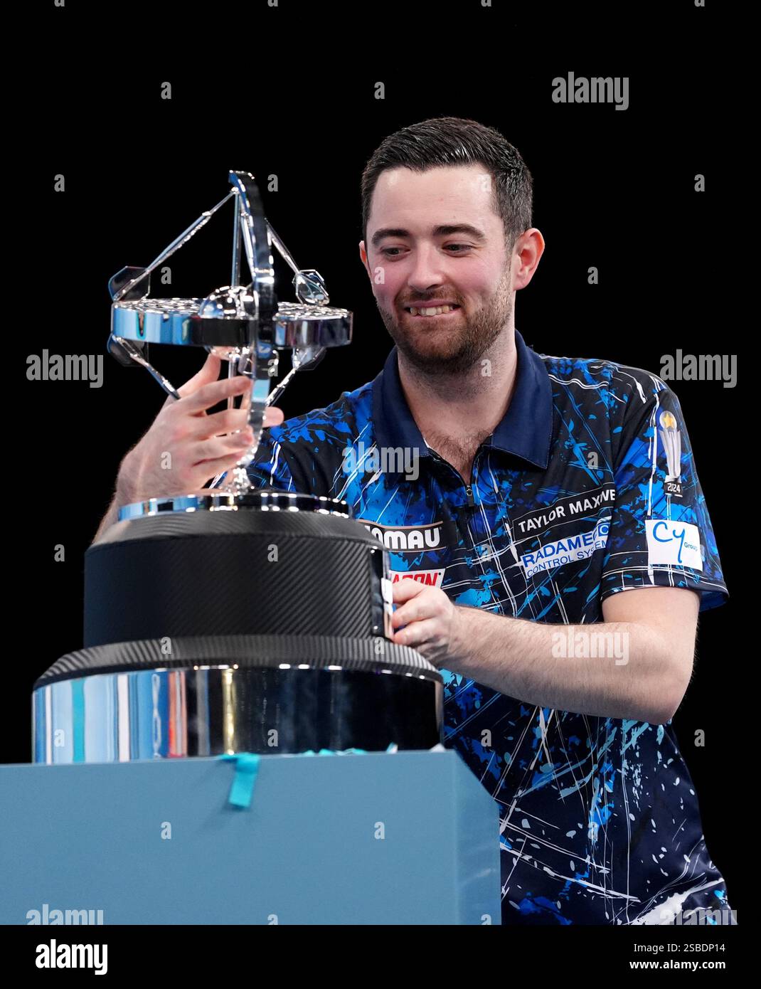 Luke Humphries celebrates with his trophy after beating Jonny Clayton ...