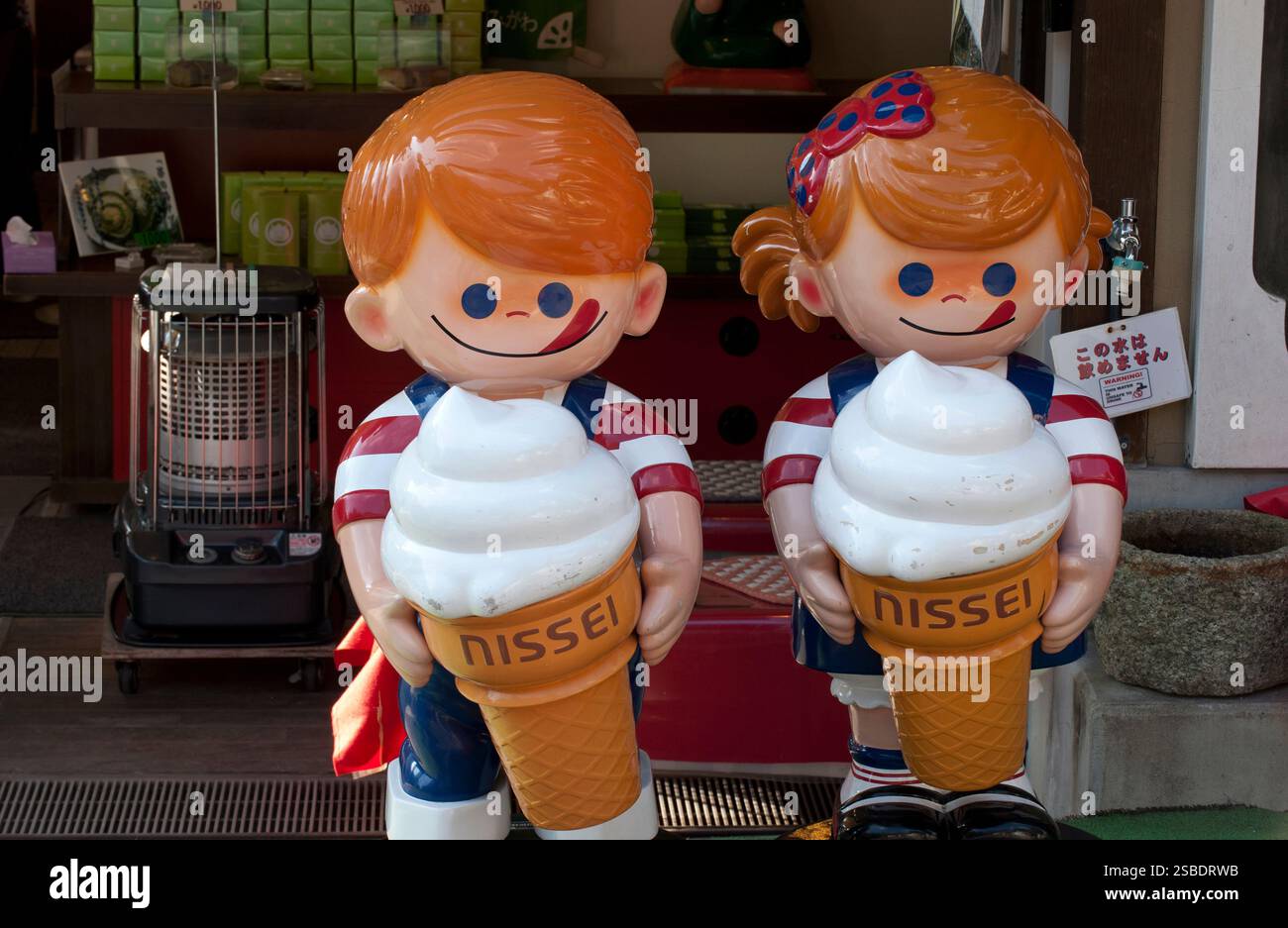 Boy and girl mannequin dolls holding Nissei soft serve ice cream cones ...