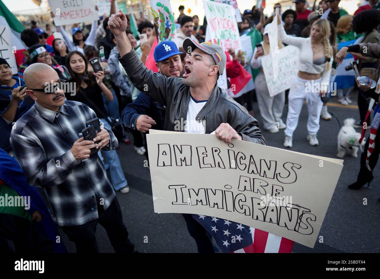 Demonstrators hold signs and shout slogans during a protest calling for ...
