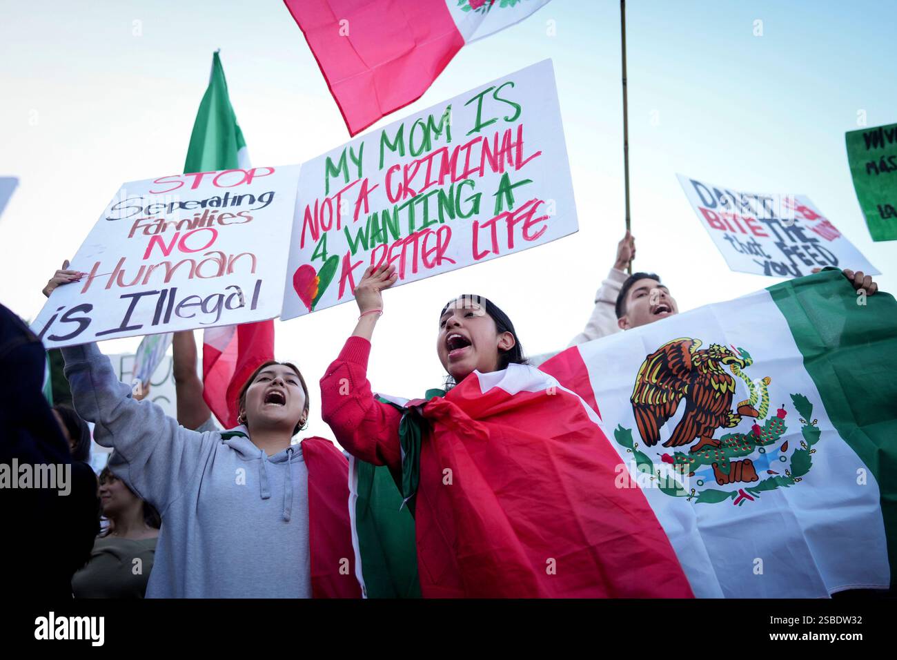 Demonstrators hold signs and shout slogans during a protest calling for ...