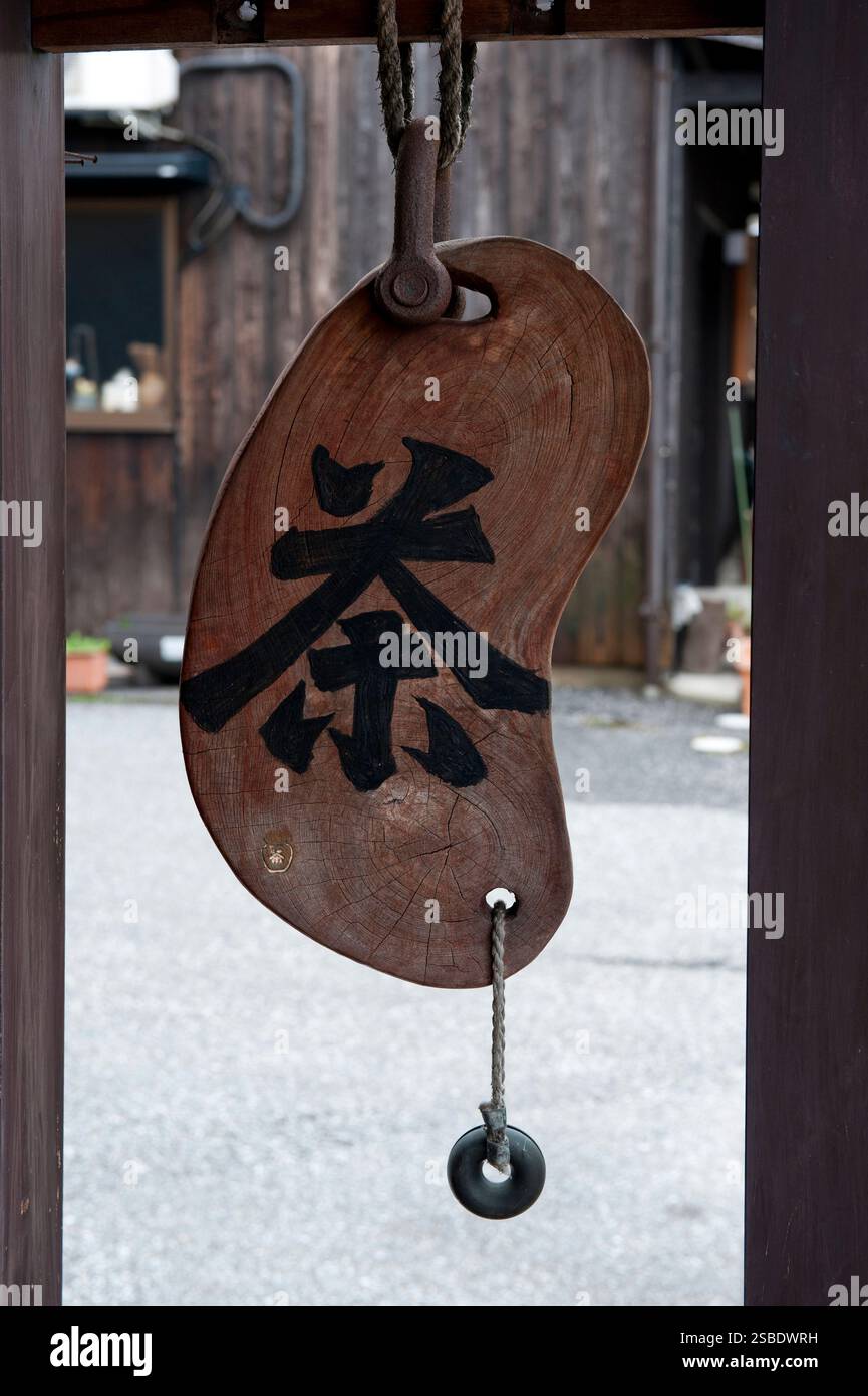 Artistic wooden signboard outside a shop advertising "cha" using the ...