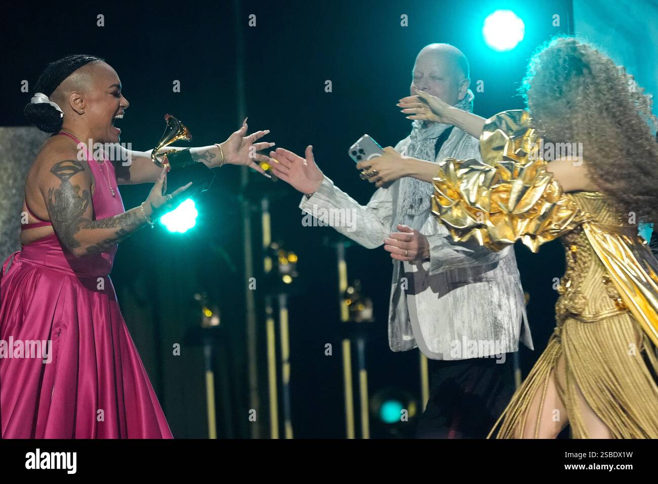 Queen Sheba, left, presents Angela Benson with the award for best ...
