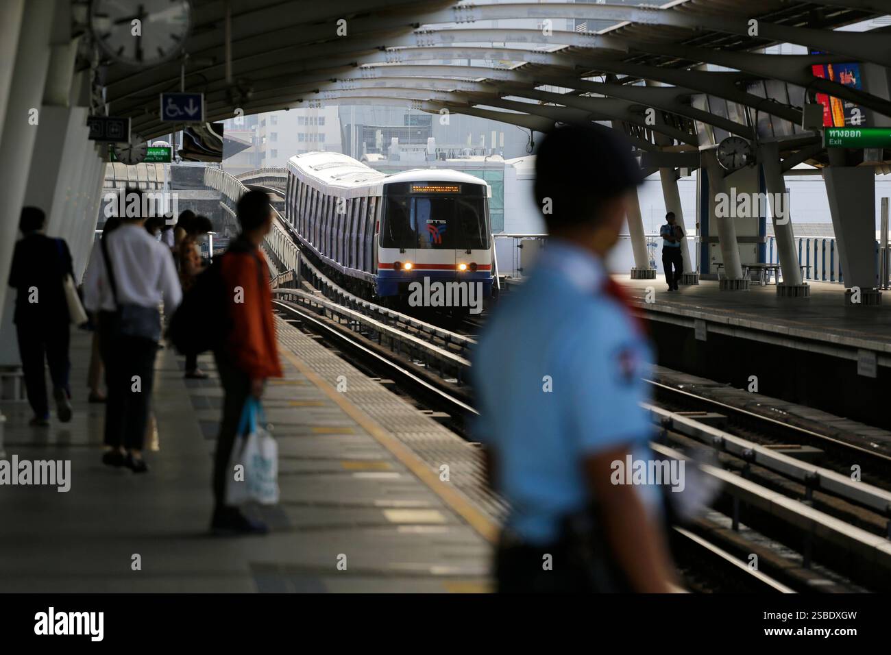 Bangkok, Thailand - February 5, 2023: Passengers wait for a BTS Skytrain elevated rapid mass ...