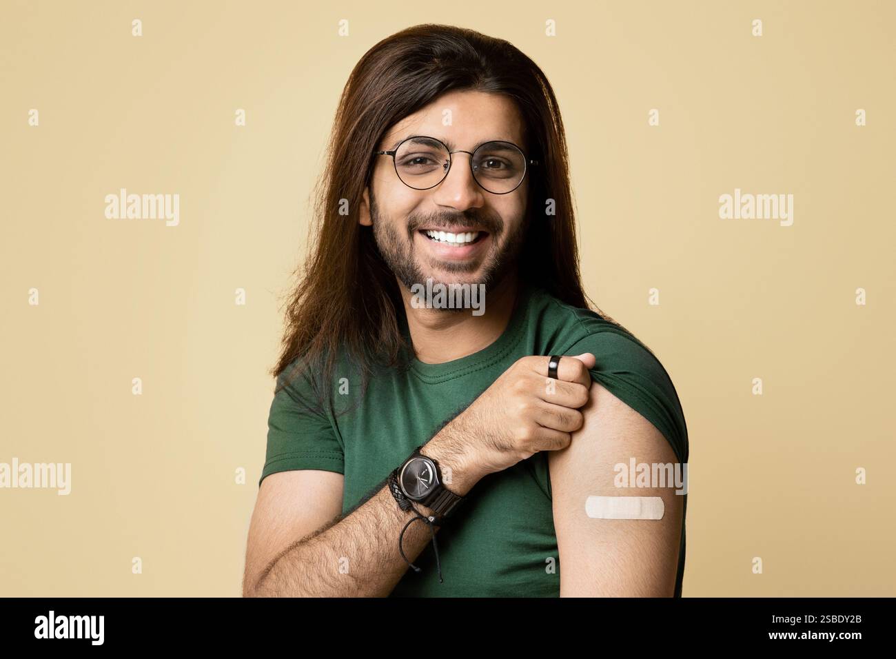 Handsome indian man got vaccinated, showing shoulder with plaster Stock ...