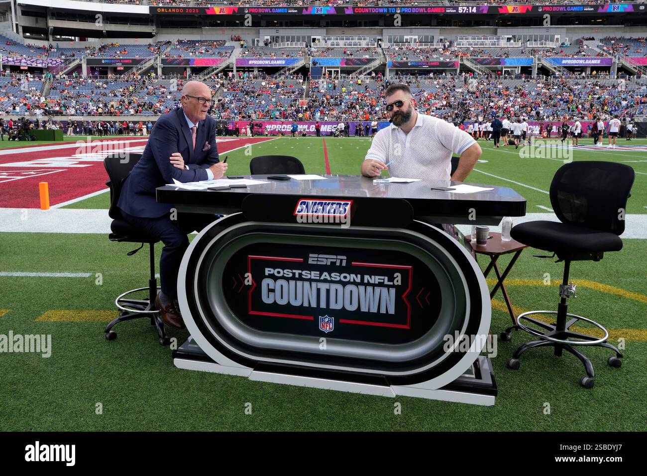 Scott Van Pelt, left, and Jason Kelce work from the field before the ...