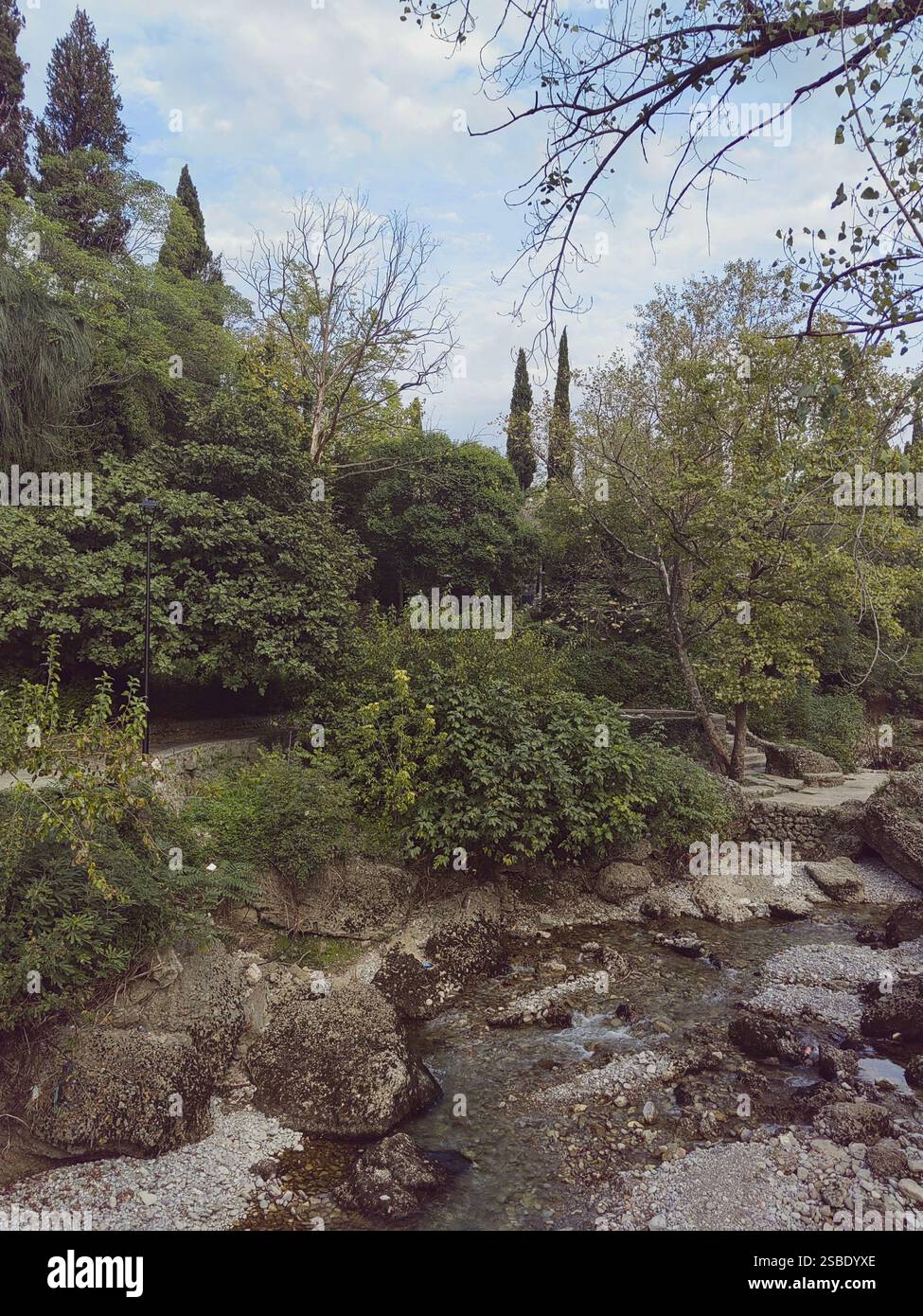 A historical site with stone buildings in the forest by the river in ...