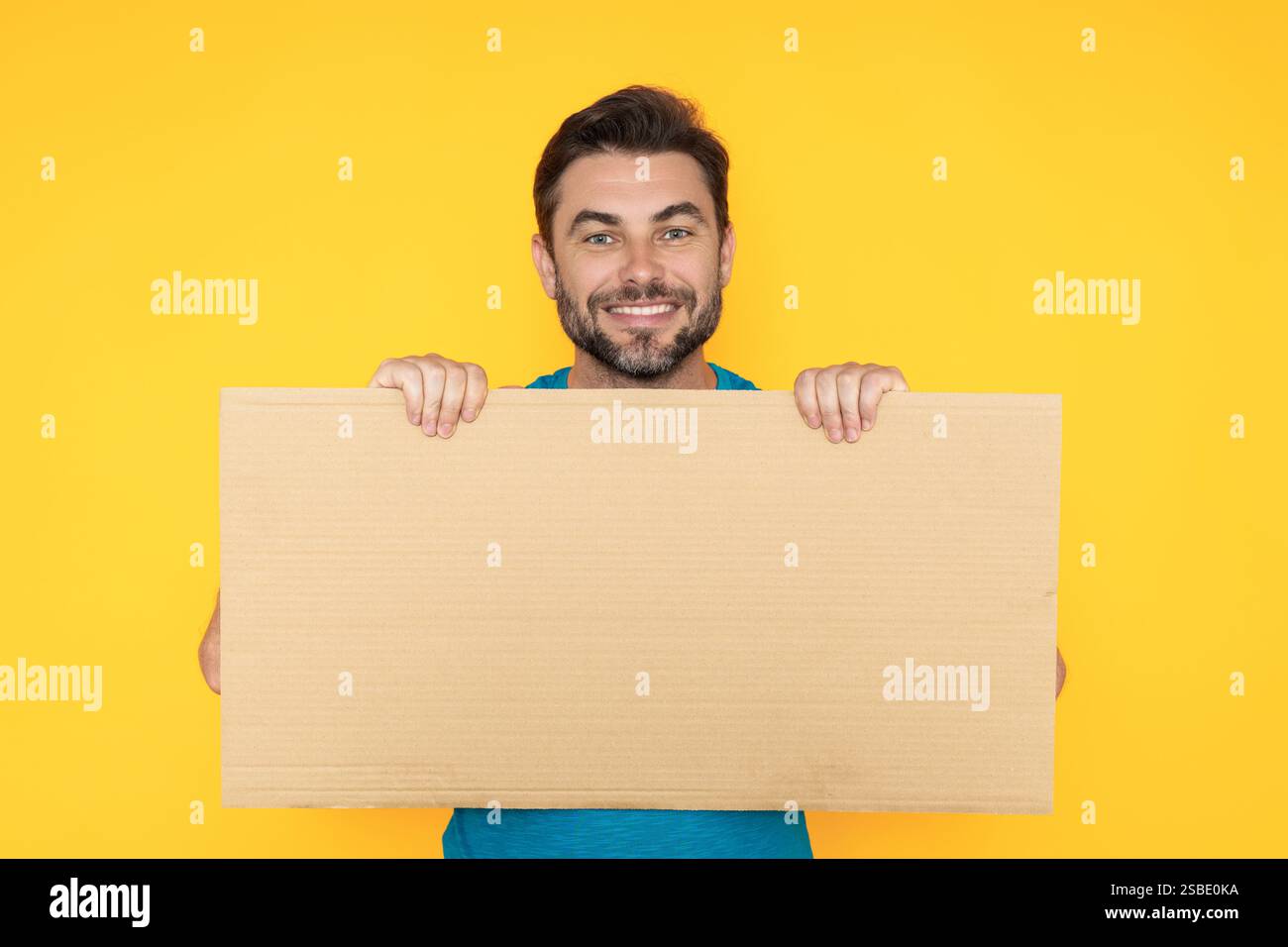 Happy man holds the sign, blank card placard. Sign to your text ...