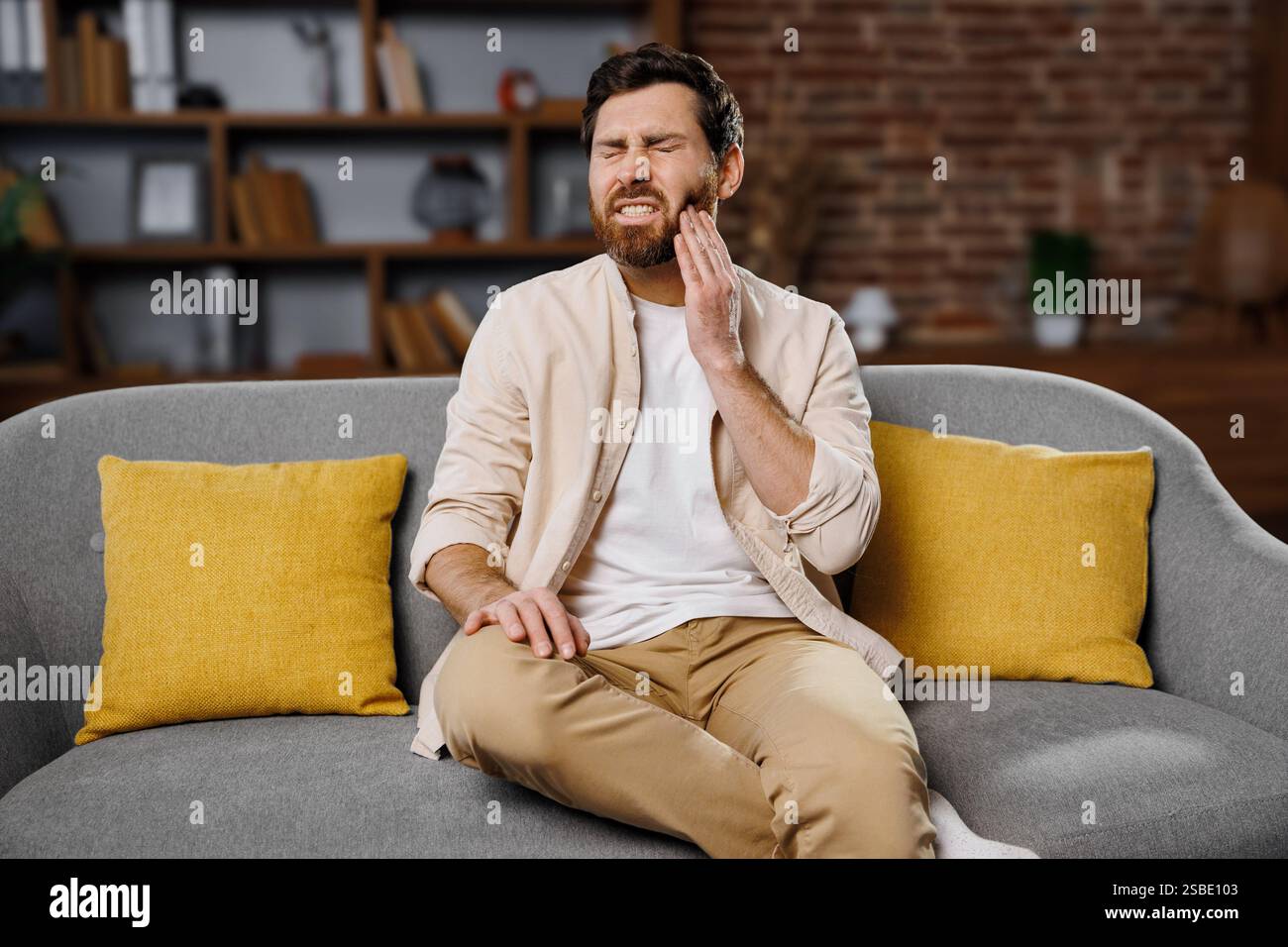 severe toothache, Upset man, holds his cheek, Man experiencing tooth ...