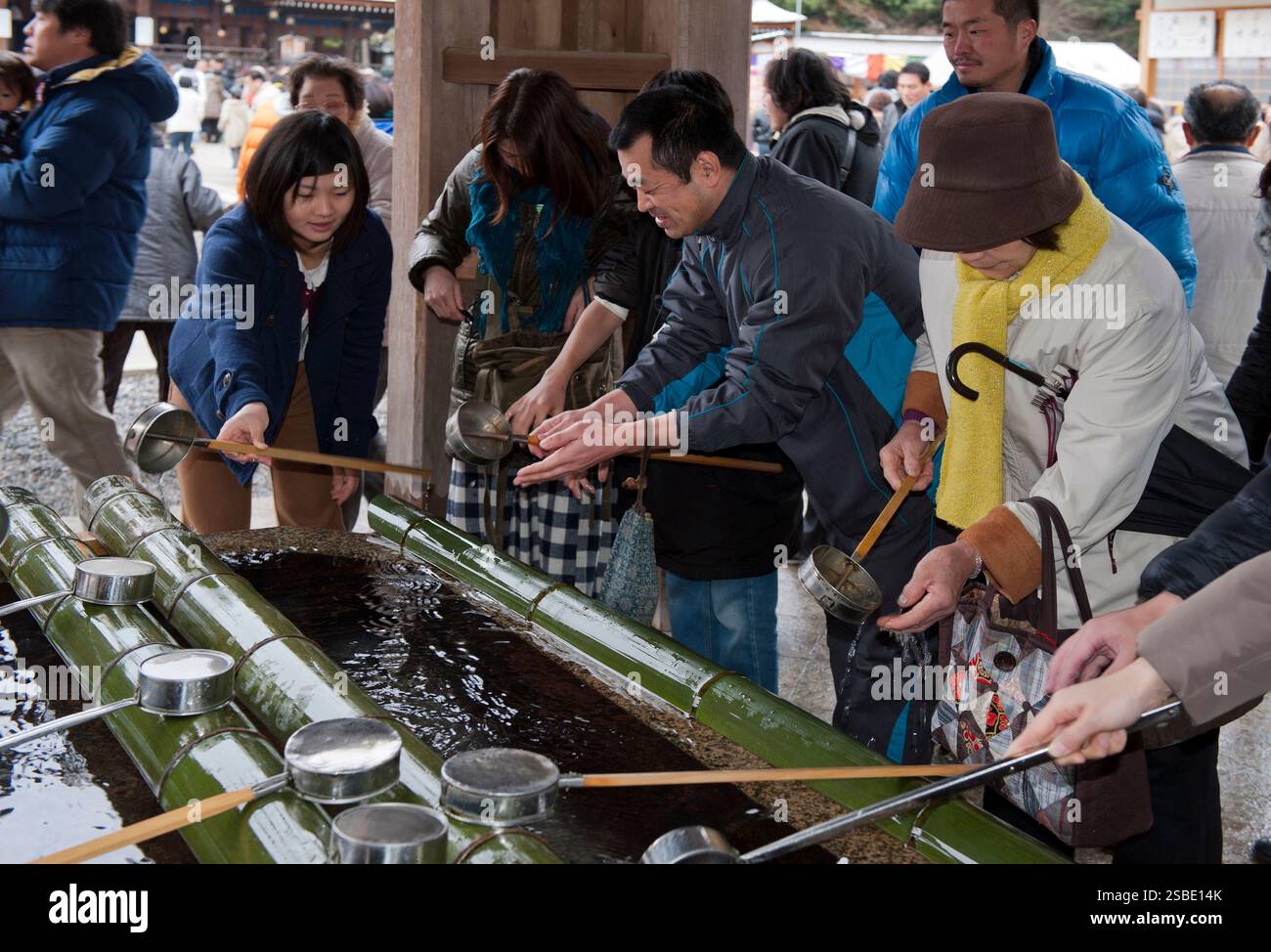 People washing hands and mouth at a "temizuya" water basin in a ...