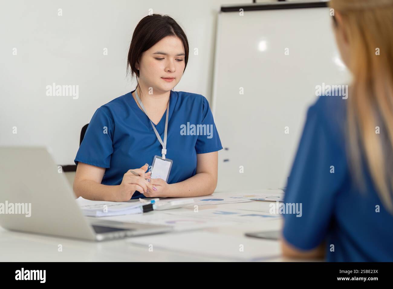 Healthcare professional discussing patient care strategies during a ...