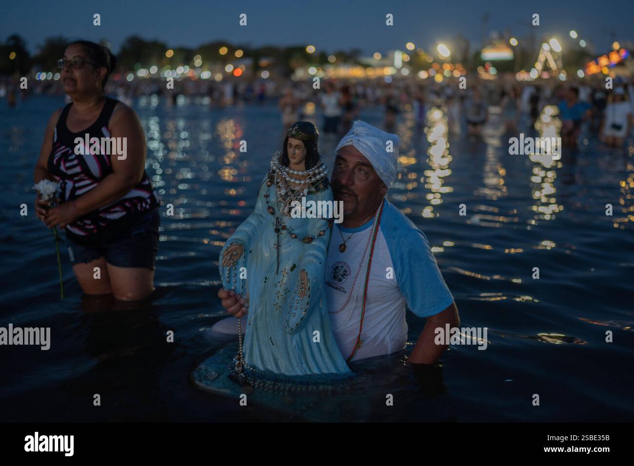 Devotees wade in the water at Ramirez Beach as part of a ritual ...
