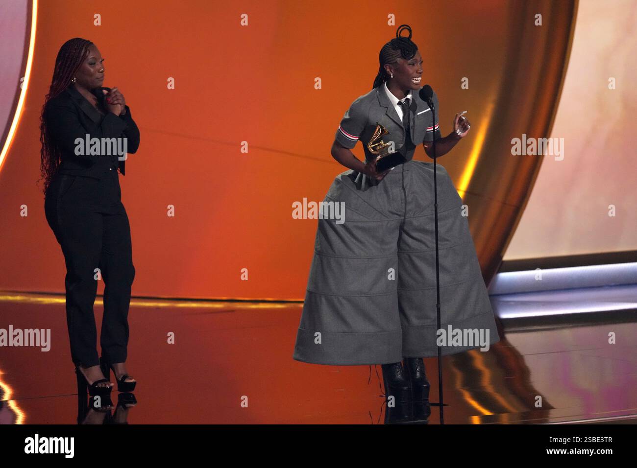 Doechii, center, accepts the award for best rap album for "Alligator ...