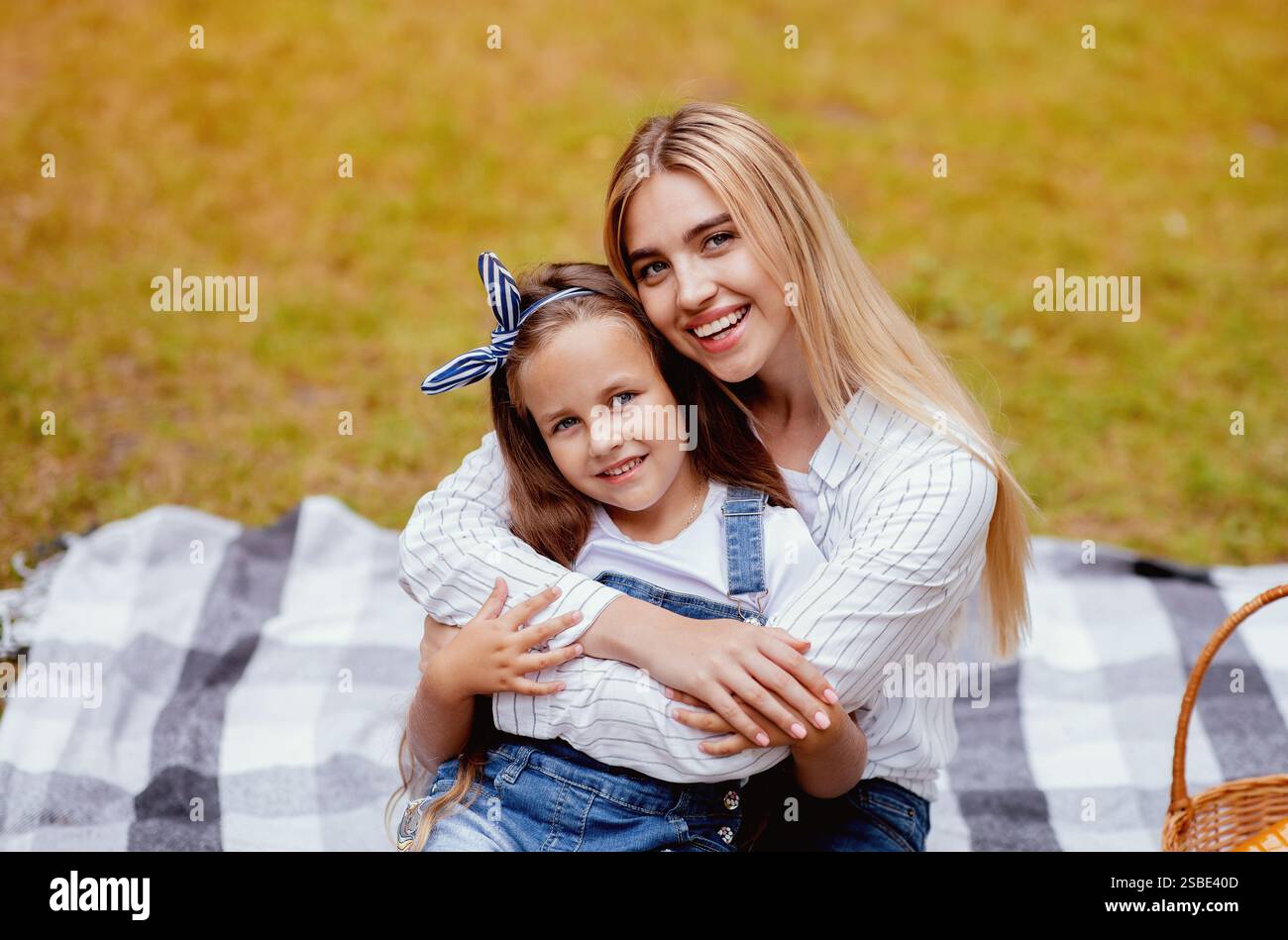 Happy Mother Hugging Her Little Daughter During Picnic In Countryside Stock Photo - Alamy