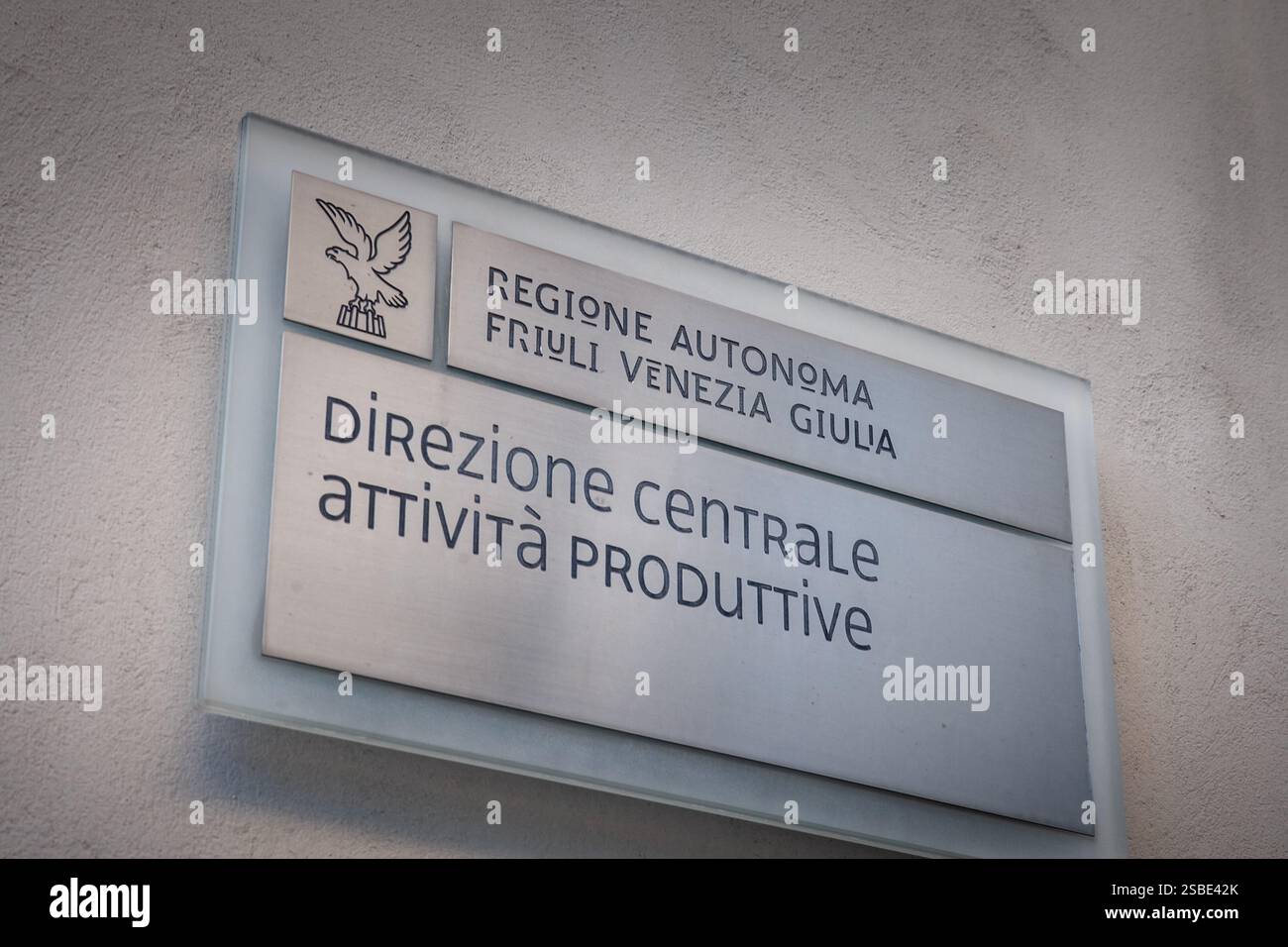 TRIESTE, ITALY - DECEMBER 19, 2024: A metal plaque displays the logo of ...