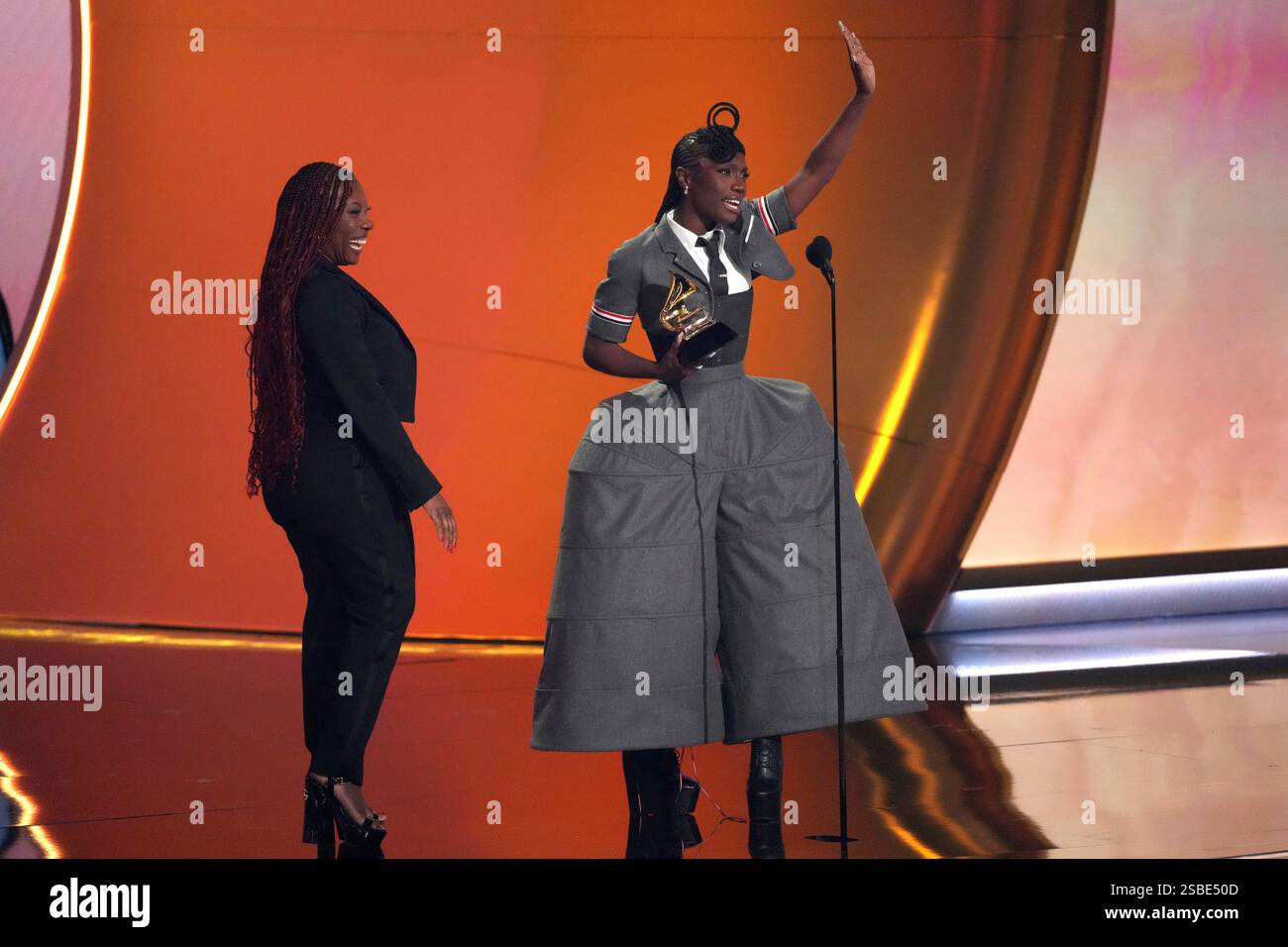 Doechii, center, accepts the award for best rap album for "Alligator ...