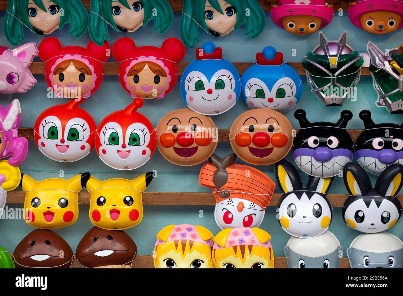 Rows of plastic Japanese anime character face masks displayed in a ...