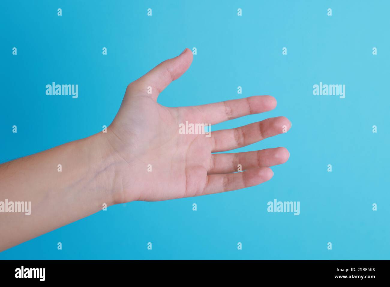 Woman with visible hand veins on light blue background, closeup Stock Photo - Alamy