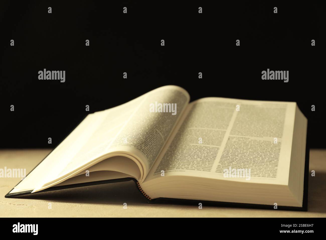 Open Holy Bible in English language on beige table Stock Photo - Alamy