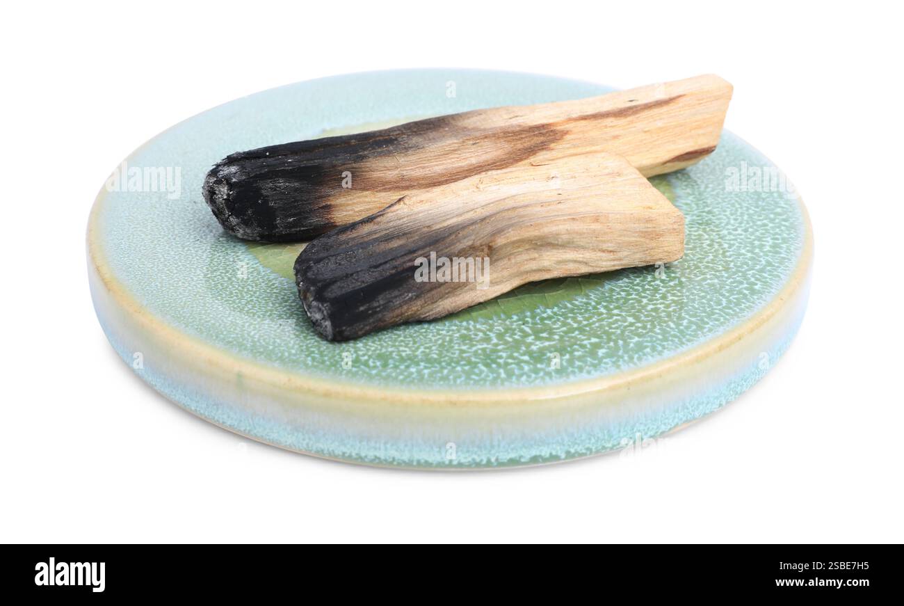 Burnt palo santo sticks on white background Stock Photo - Alamy