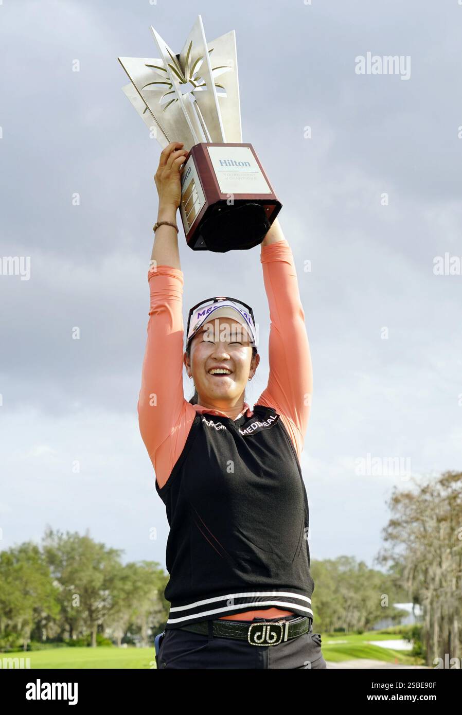 A Lim Kim of South Korea raises the victor's trophy at the Hilton Grand ...
