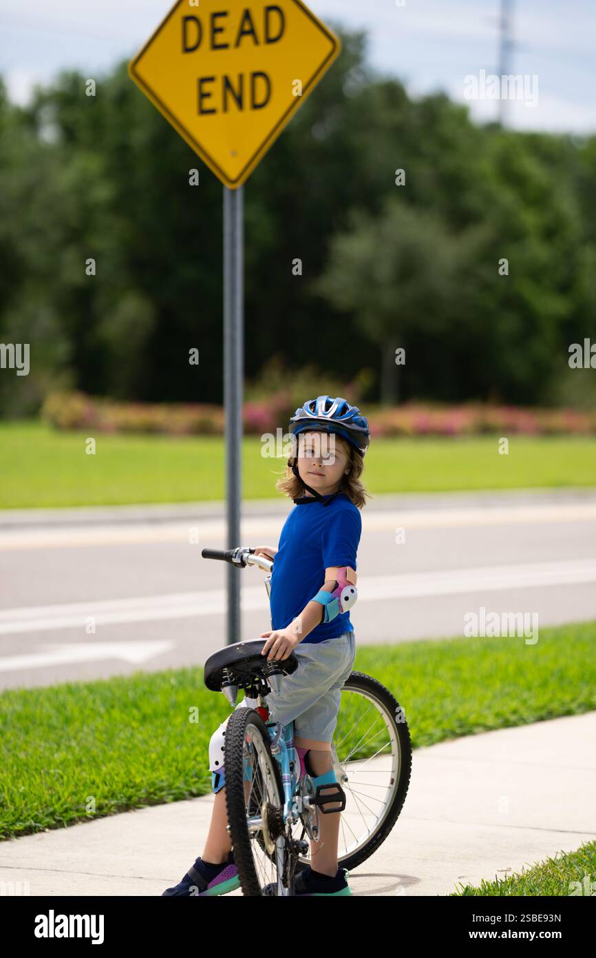 Boy in a helmet riding bike. Boy in safety helmet riding bike in city ...