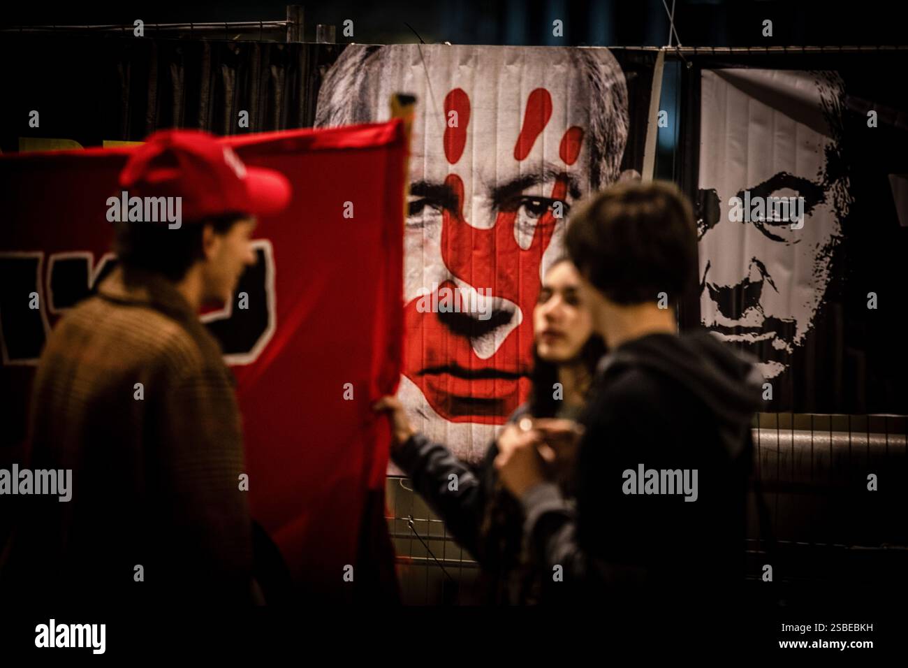 Tel Aviv, Israel. 01st Feb, 2025. Protesters stand near a depiction of ...