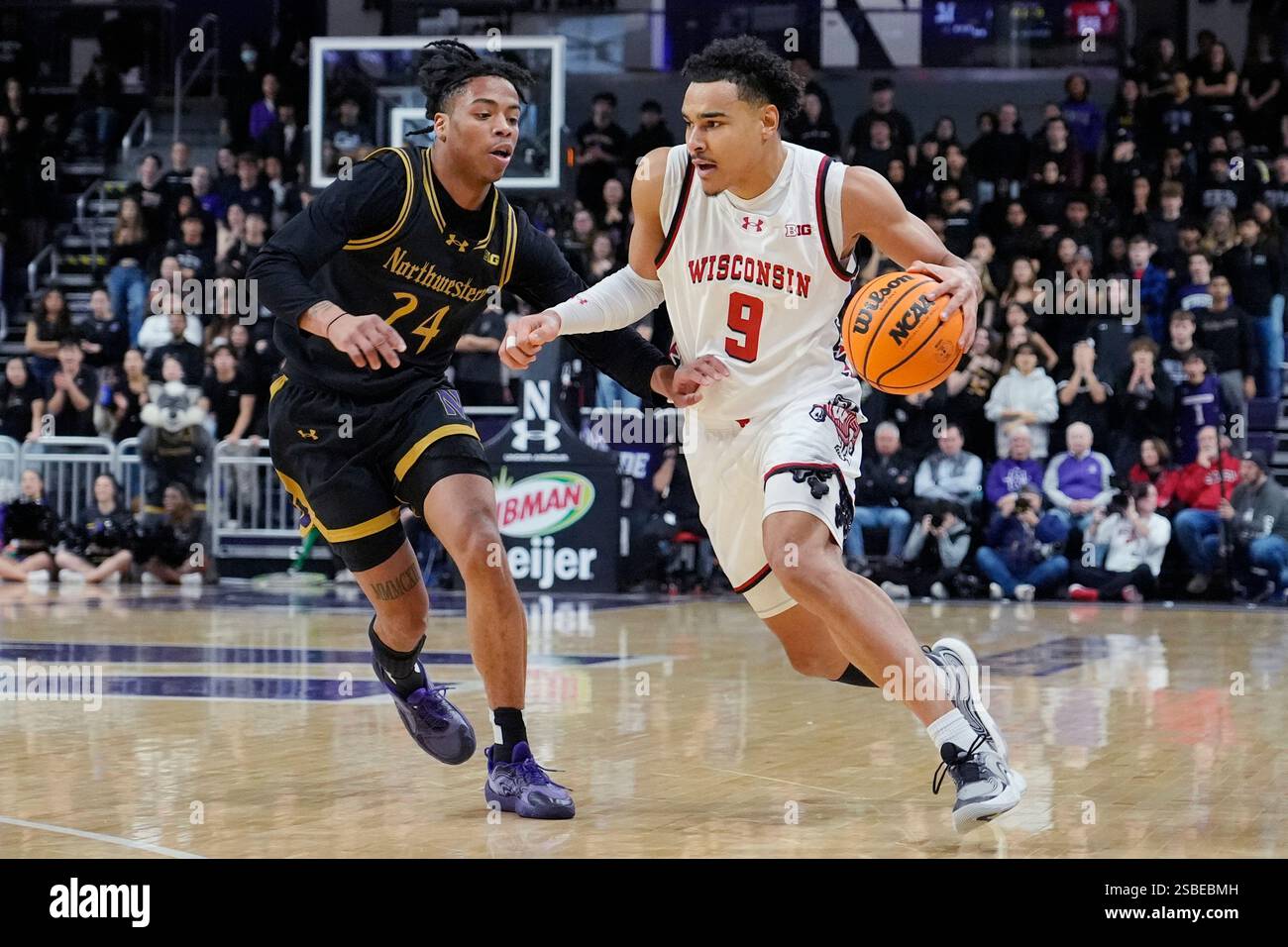 Wisconsin guard John Tonje, right, drives as Northwestern guard K.J ...