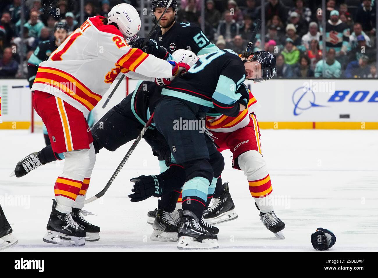 Seattle Kraken left wing Jared McCann, center, fights with Calgary ...