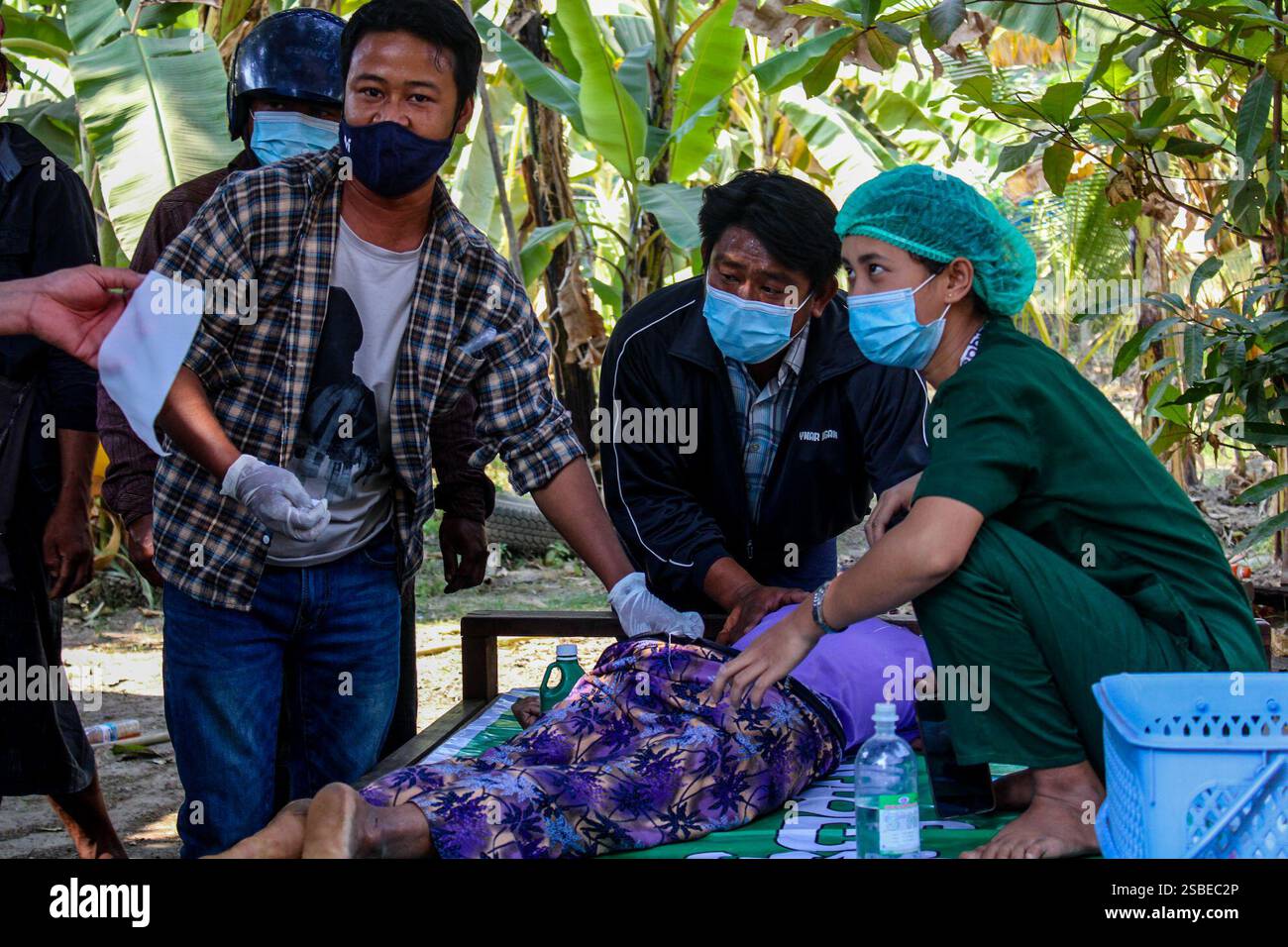 People care for an injured woman after a police assault in Salin, Minbu ...