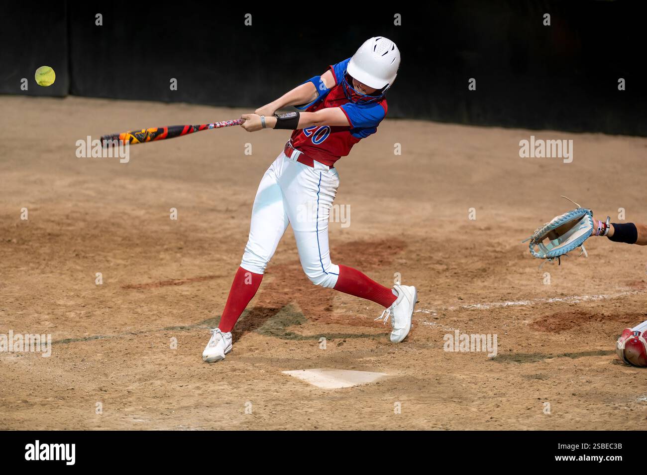 A Softball Player Is Swinging The Bat To Make Contact With The Baseball ...
