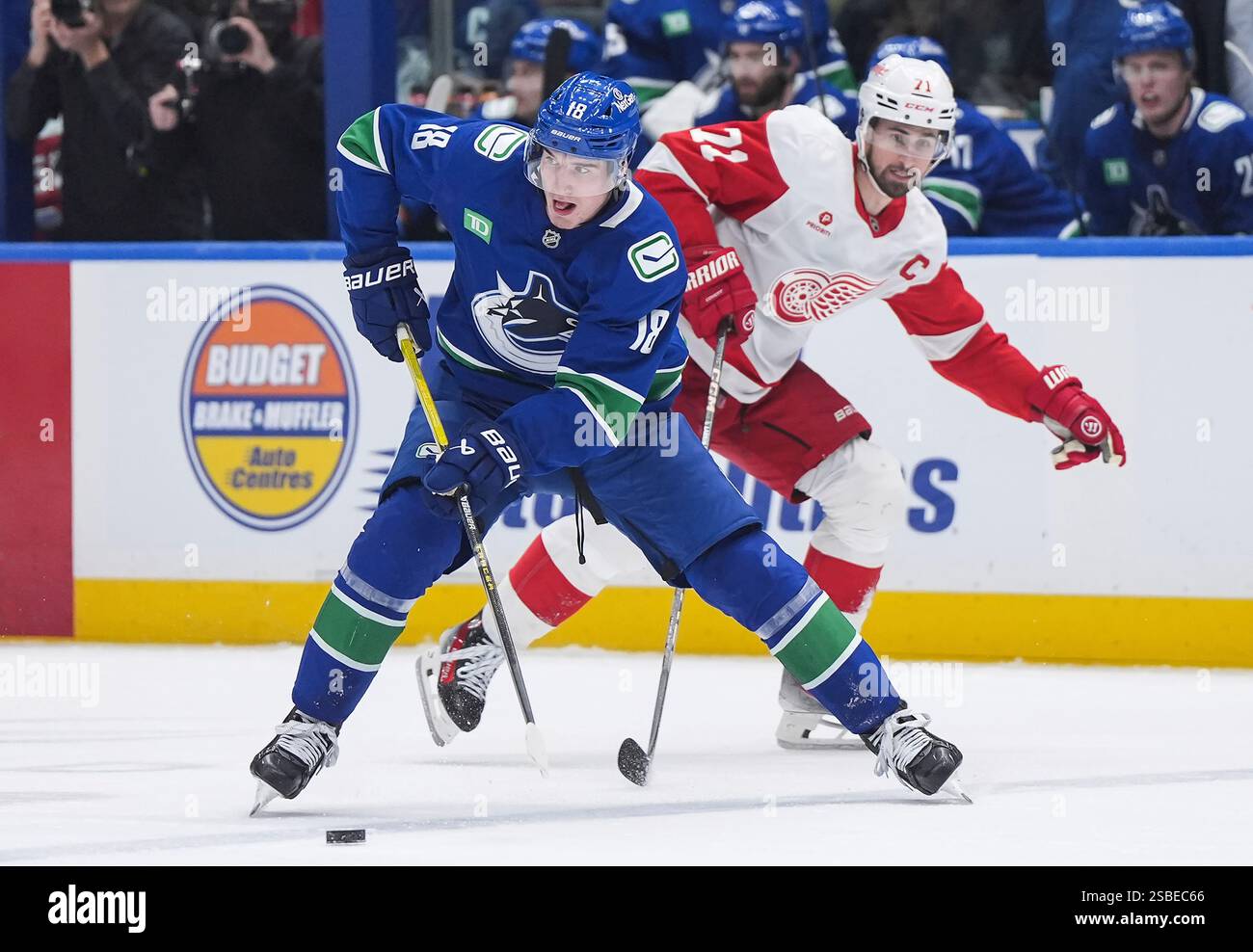 Vancouver Canucks' Drew O'Connor (18) skates with the puck under watch ...