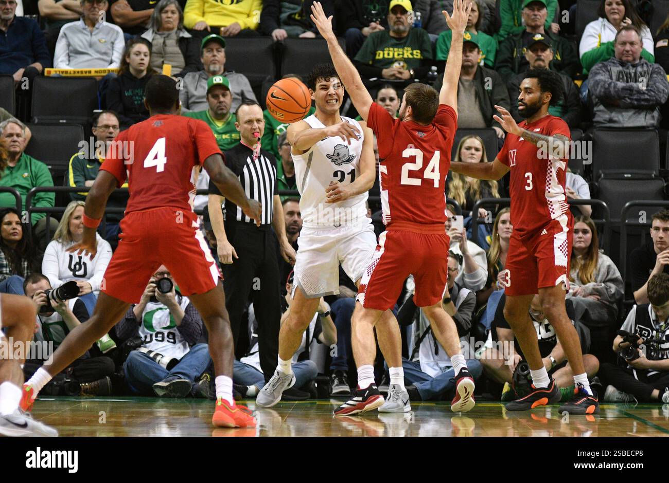 Oregon forward Brandon Angel (21) passes in between Nebraska forward ...