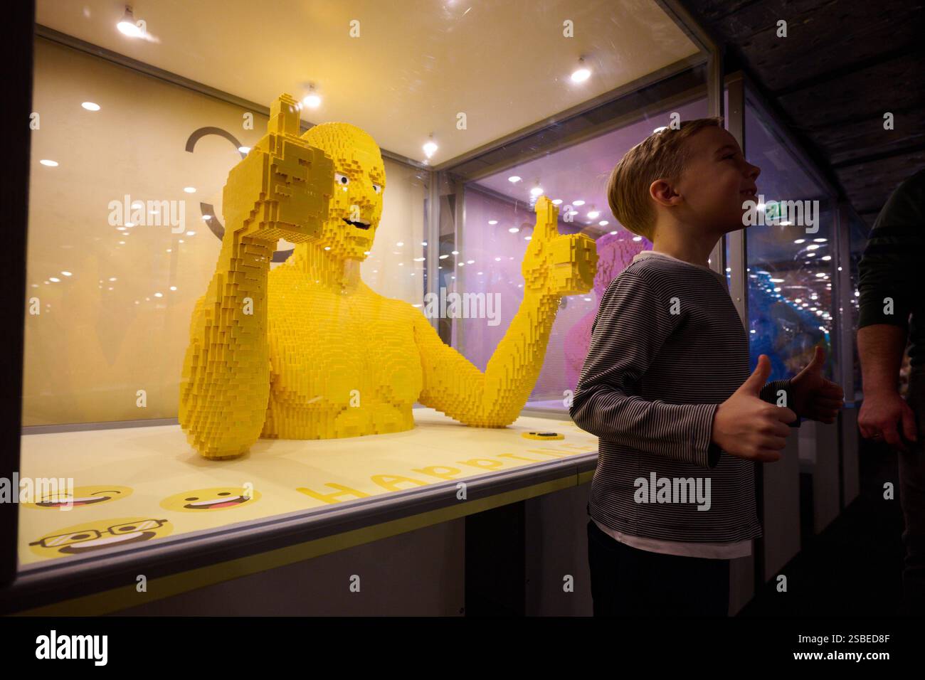 Beijing, Poland. 1st Feb, 2025. A boy mocks the posture of an exhibit ...