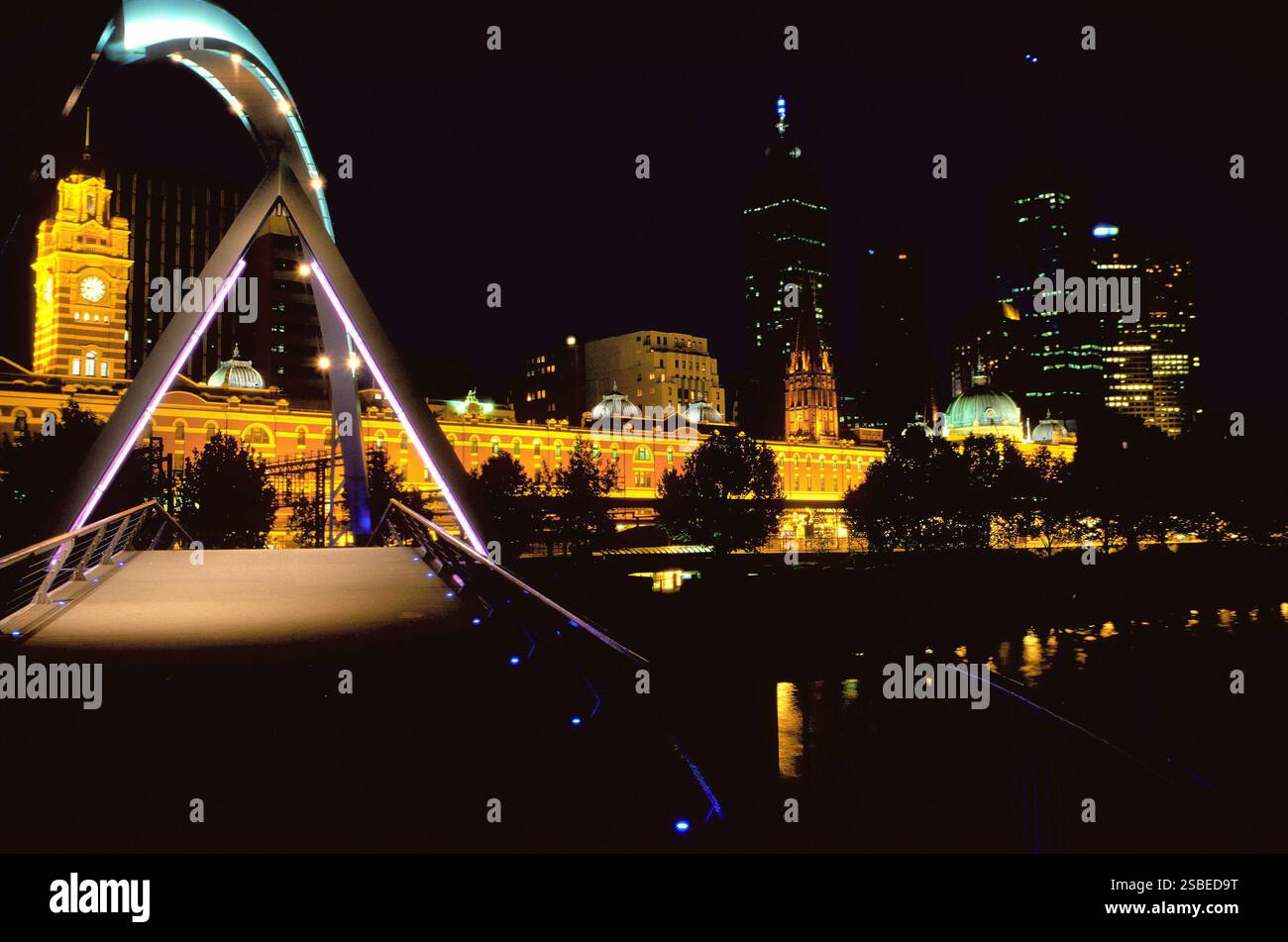 Pedestrian bridge over the Yarra River to city at night, Melbourne ...