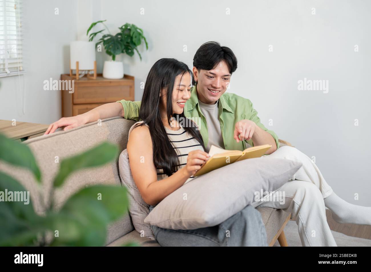 A lovely, happy young Asian couple, a boyfriend and girlfriend, enjoy ...