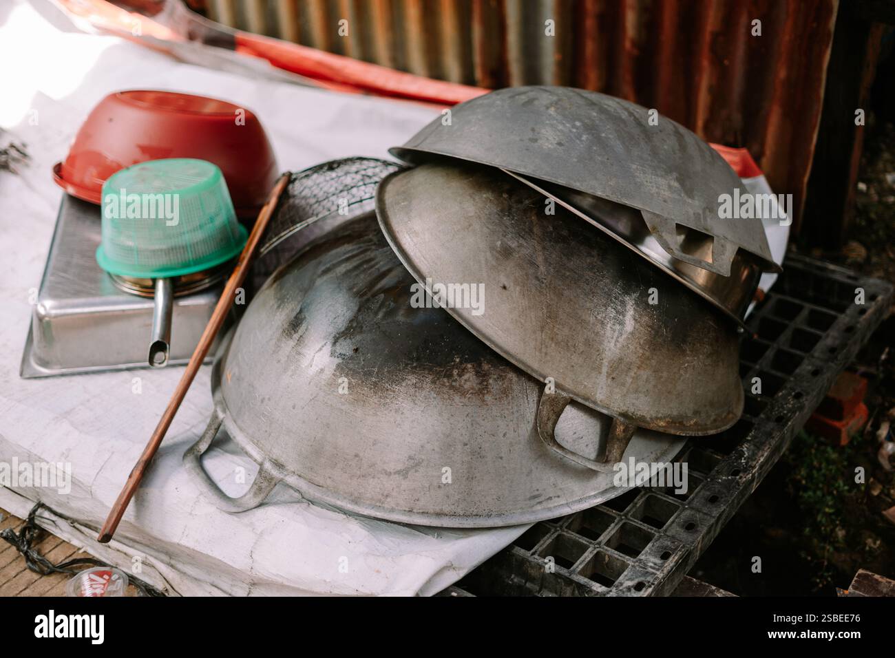 Stack of well-used woks, showing signs of cooking and wear Stock Photo ...