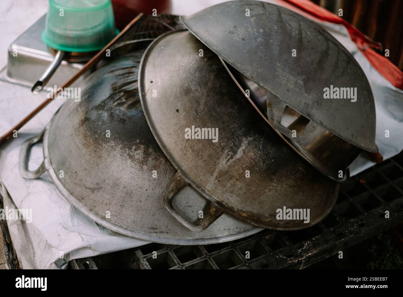 Stack of well-used woks, showing signs of cooking and wear Stock Photo ...