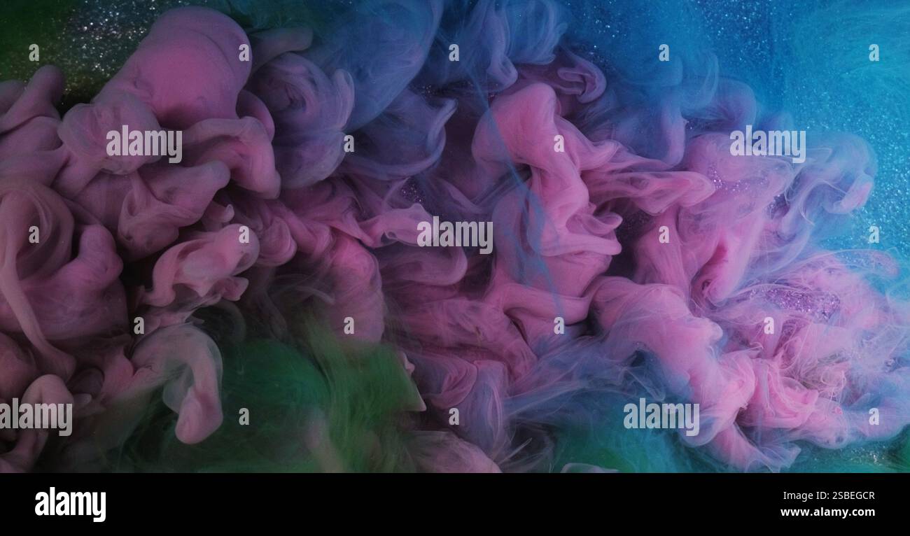 Color water flow. Ink smoke. Defocused pink green blue glowing splashes ...