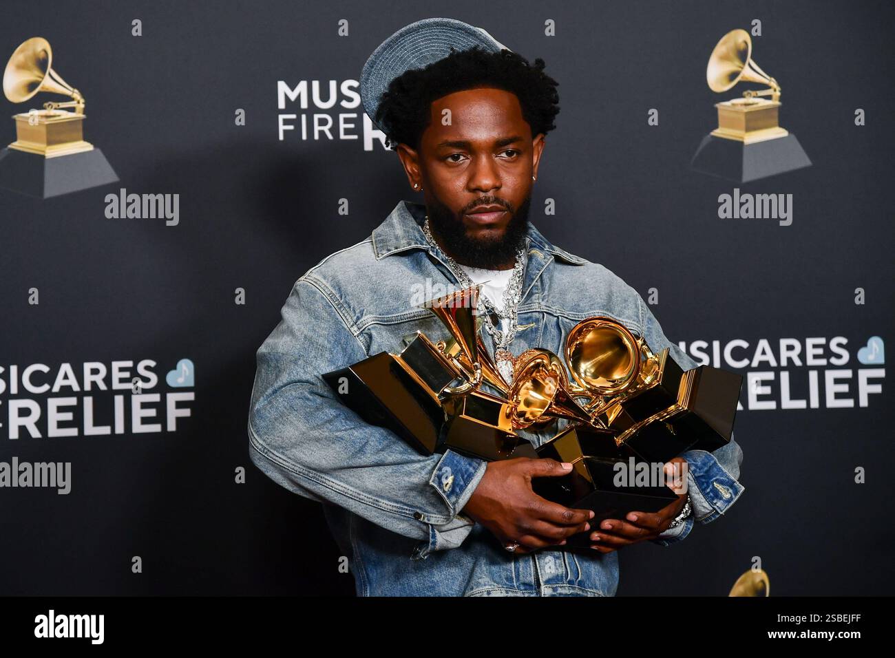 Kendrick Lamar poses in the press room with the award for record of the ...