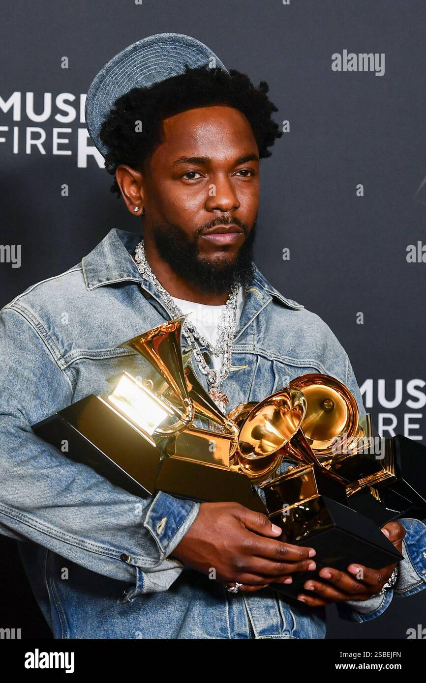 Kendrick Lamar poses in the press room with the award for record of the ...